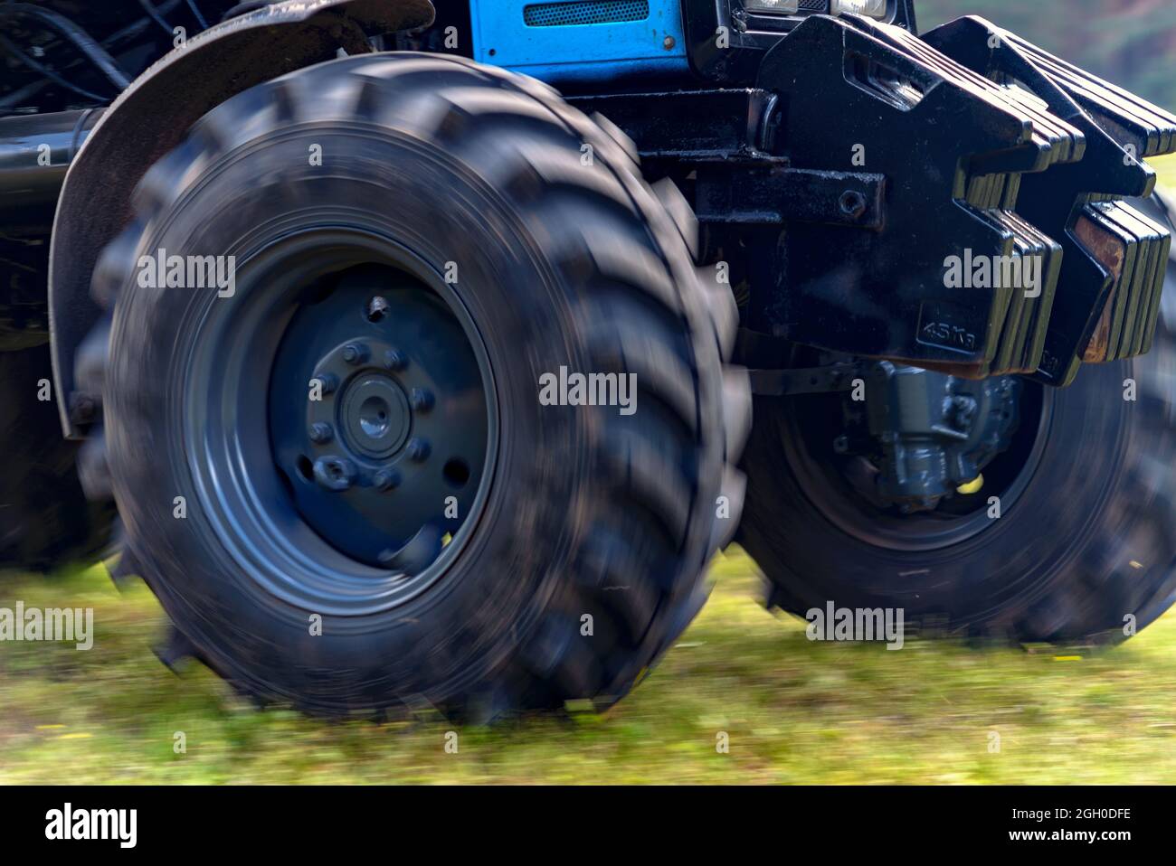 Powerful tractor wheels go over the ground up dust.A small movement ...