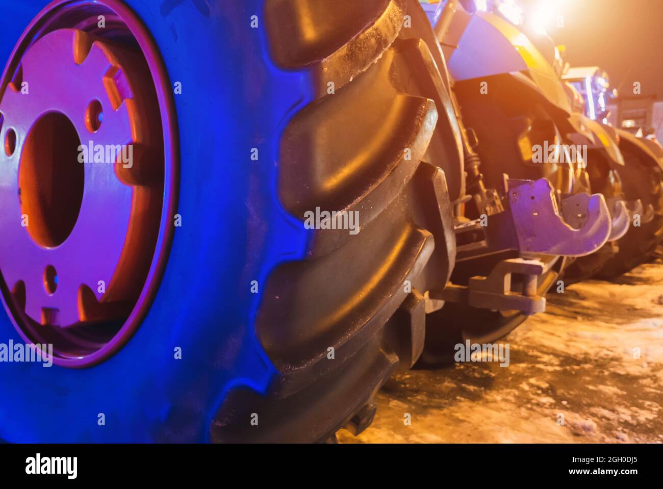 Big rubber wheels of a tractor. Tractors stand in a row Stock Photo - Alamy