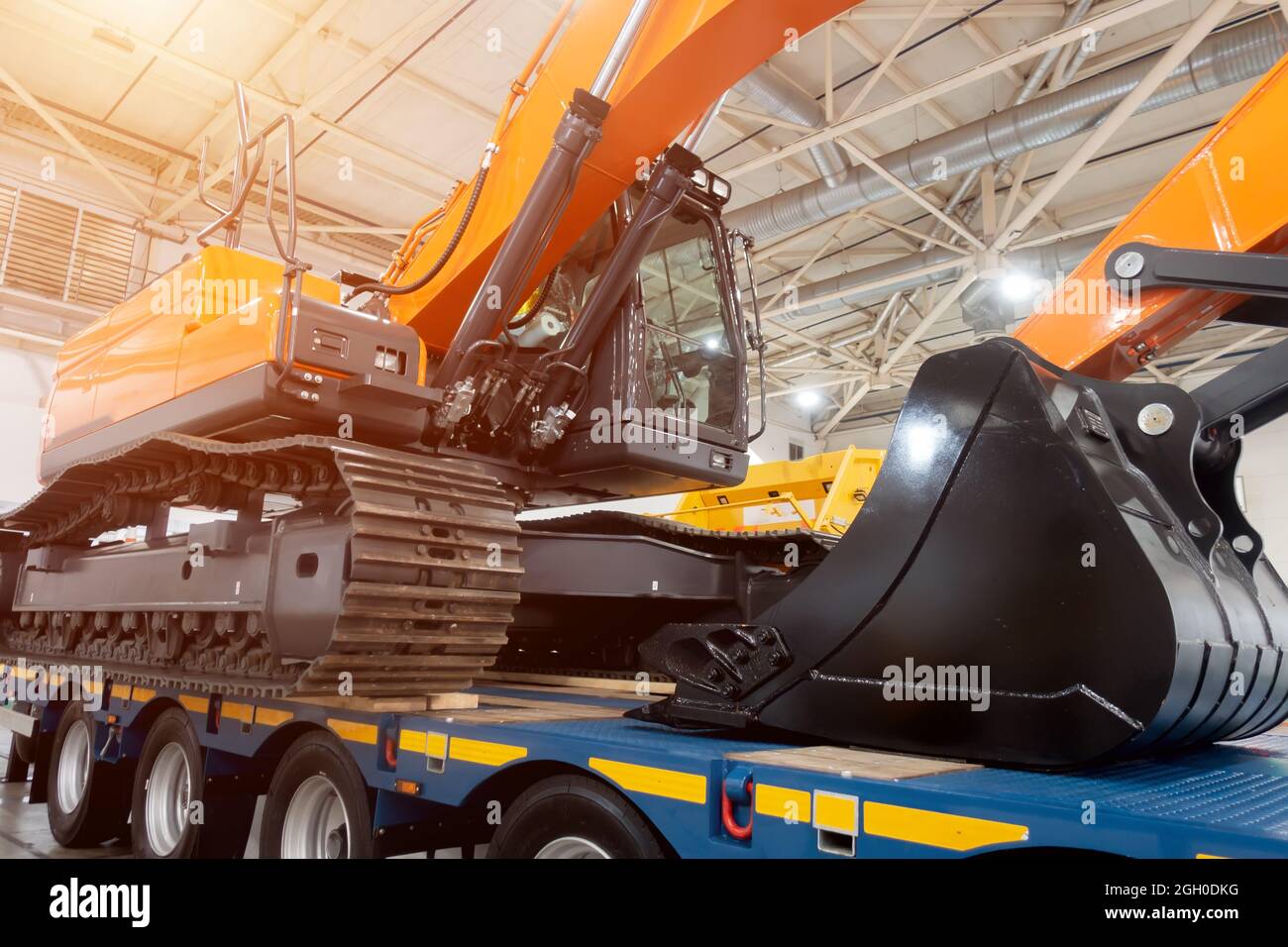 Excavator on a platform for transporting cars Stock Photo - Alamy
