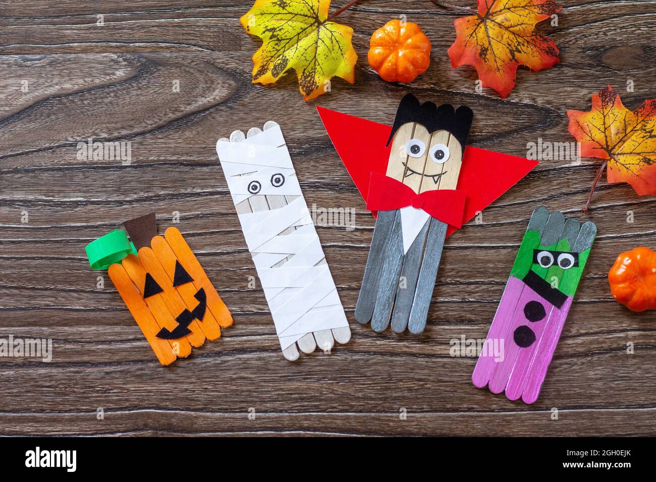 Child is holding Halloween ghost and vampire toy gift stics puppets on ...