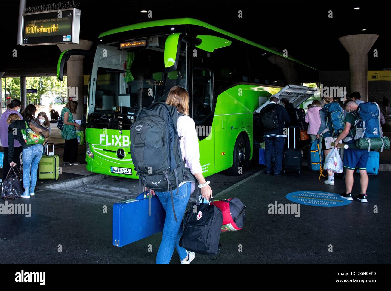 Munich, Germany. 04th Sep, 2021. Travellers stand by a bus at the bus ...