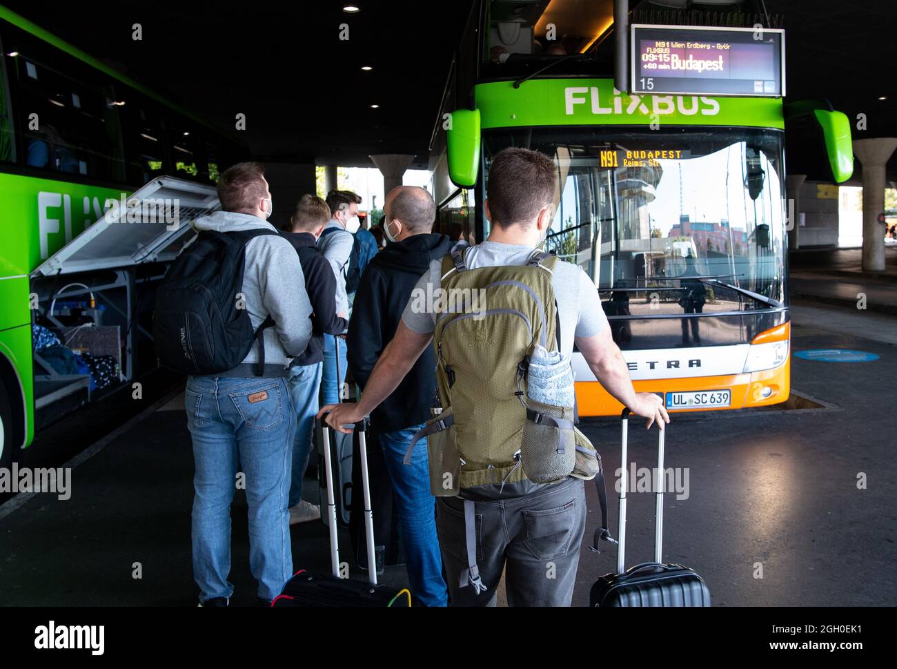 Munich, Germany. 04th Sep, 2021. Travellers stand by a bus at the bus ...