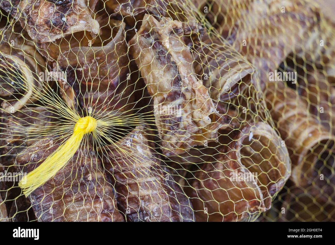 Treats for dogs in a packing net. Dried beef trachea. Chewy trea Stock ...