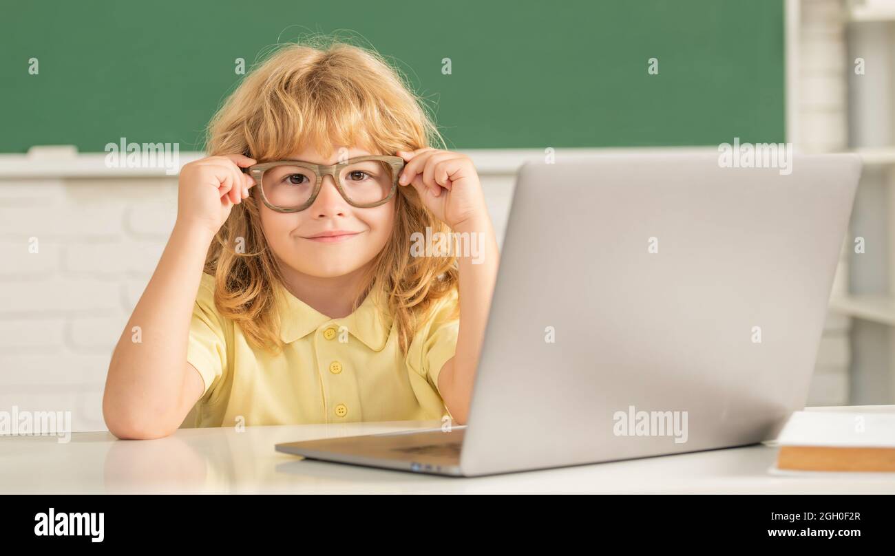 e-learning. child studying on computer. smiling teen boy in classroom ...