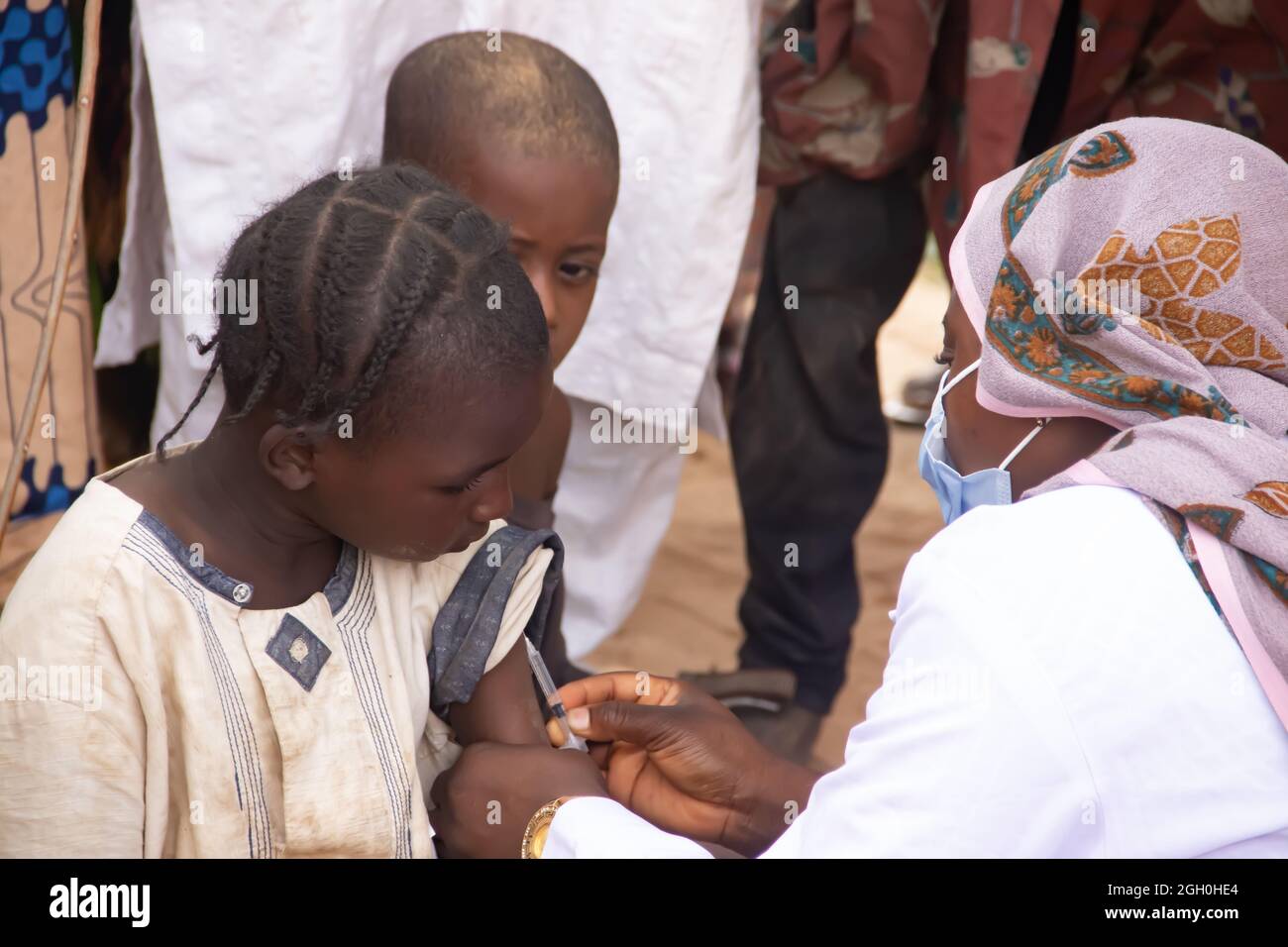 Medical worker doing routine immunization vaccination for children in ...