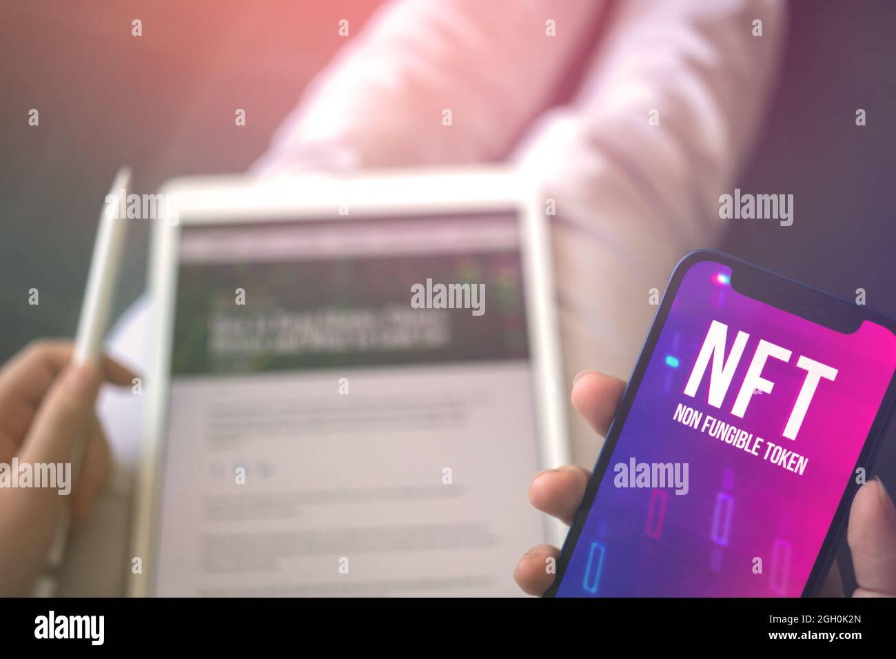 NFT logo on screen. Non fungible token, crypto art in real life concept ...