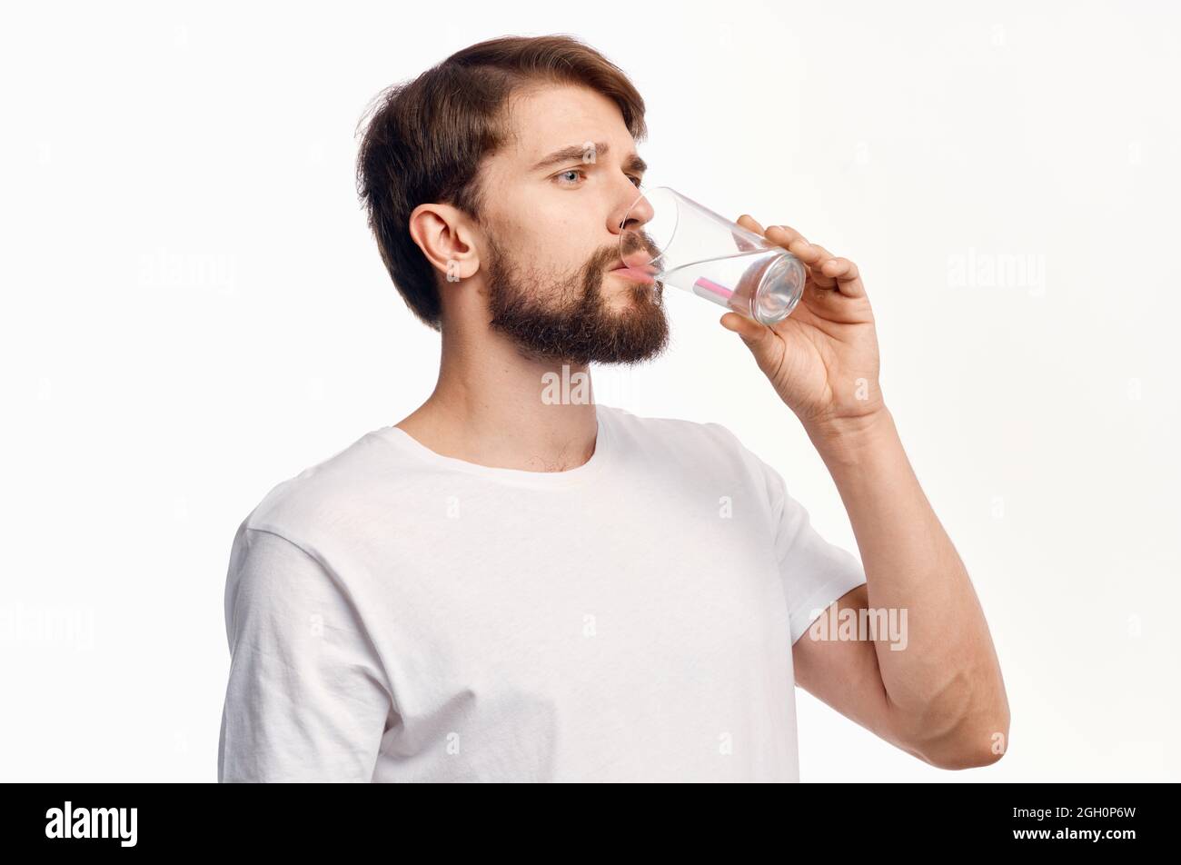 handsome man drinking water isolated background Stock Photo - Alamy
