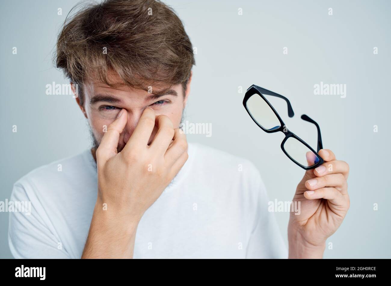 man with poor eyesight health problems light background Stock Photo - Alamy