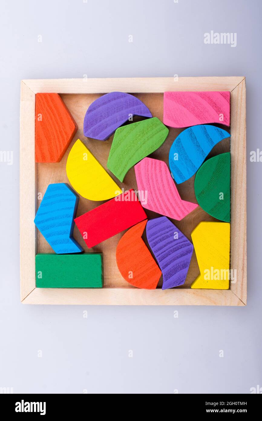 Colorful wooden pieces of a logic puzzle Stock Photo - Alamy
