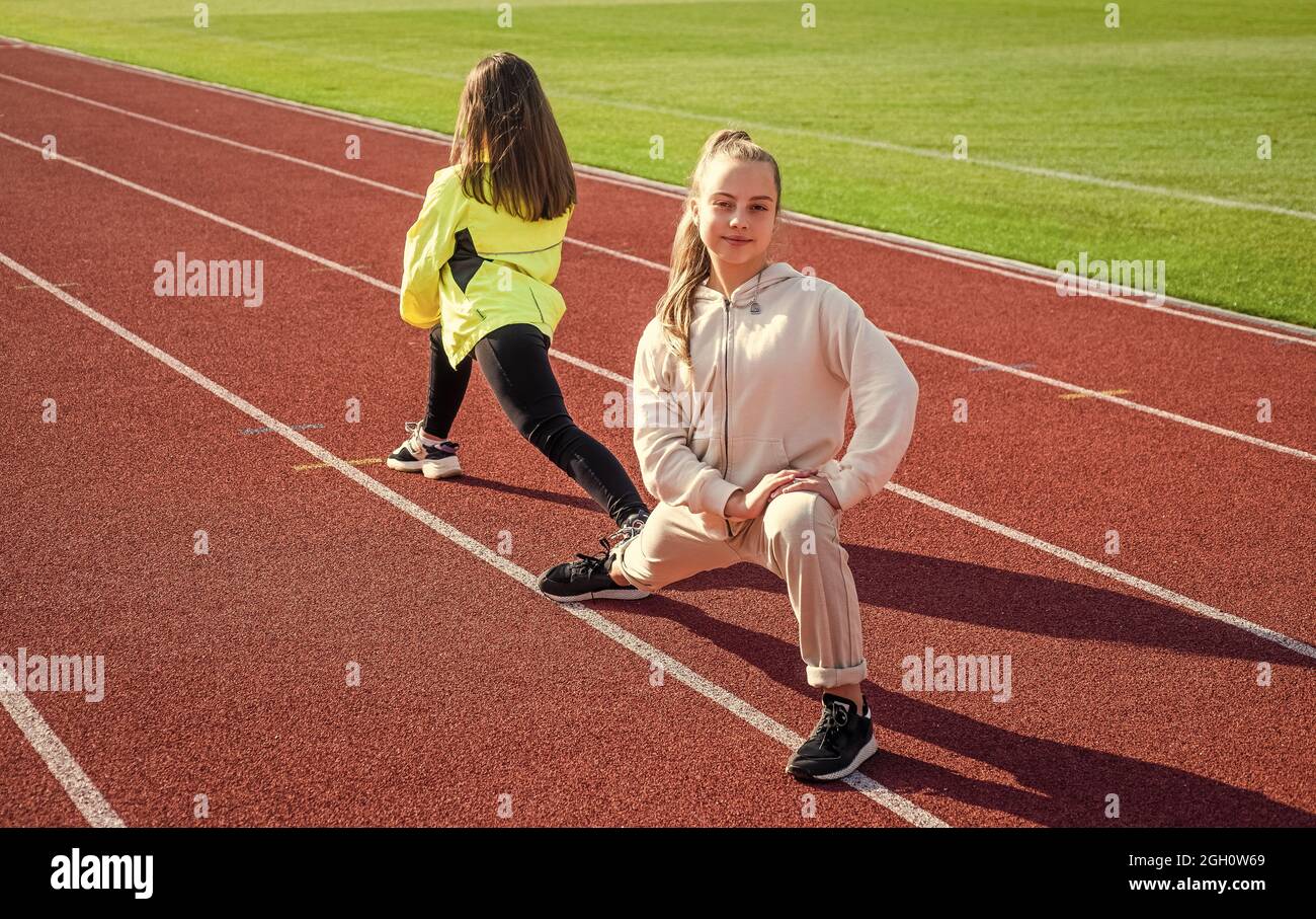 healthy children girls training fitness on stadium running track, sport ...