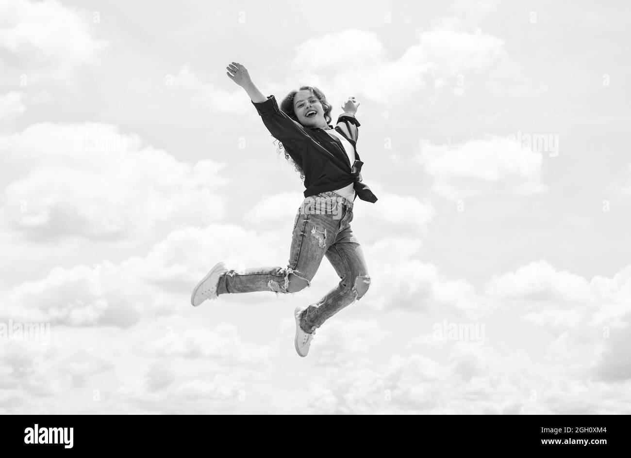 happy energetic kid feeling free and jumping high, freedom Stock Photo ...