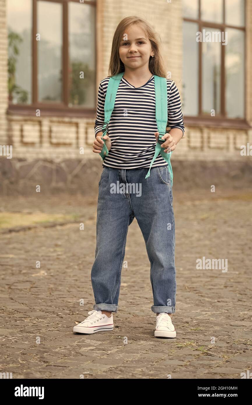 Making childhood interesting. Preschool child carry backpack outdoors ...