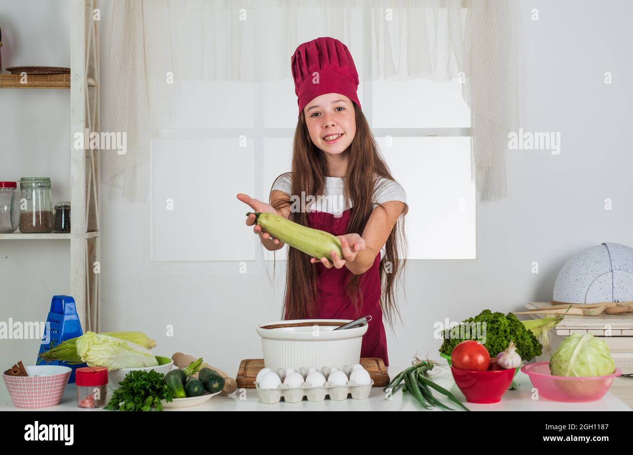 kid cooking food in kitchen. choosing a career. little helper with ...