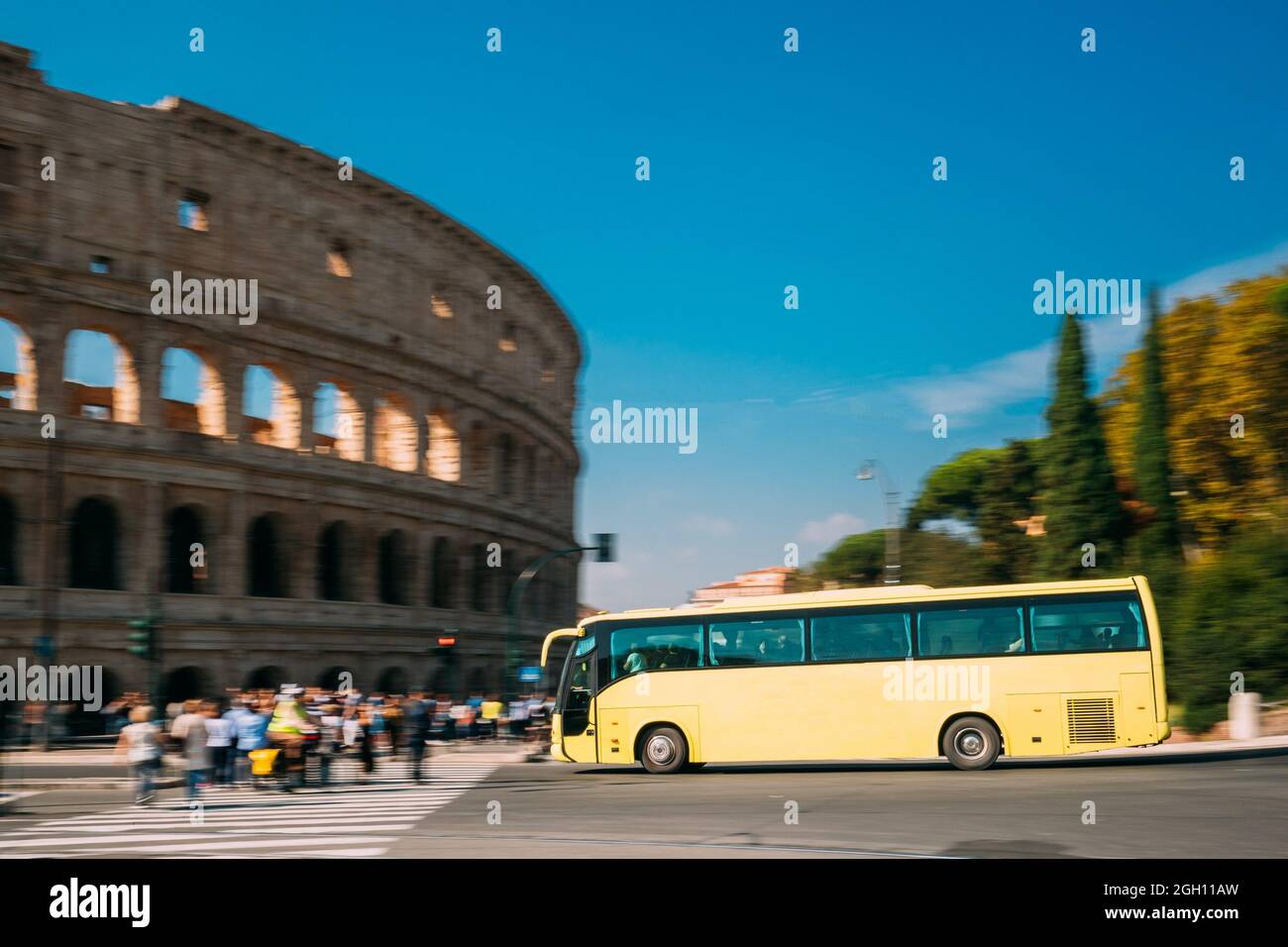 Rome, Italy. Colosseum. Yellow Bus Moving On Street Near Flavian ...