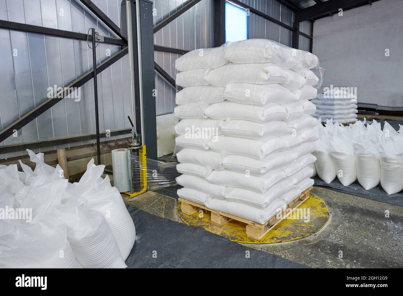 Wrapping white bags to plastic on wooden pallet Stock Photo - Alamy