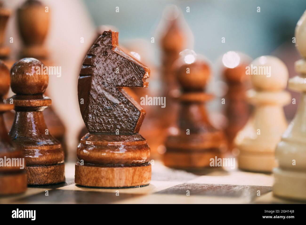 Old Brown Chess Knight and Pawns Standing On Wooden Chessboard Stock ...