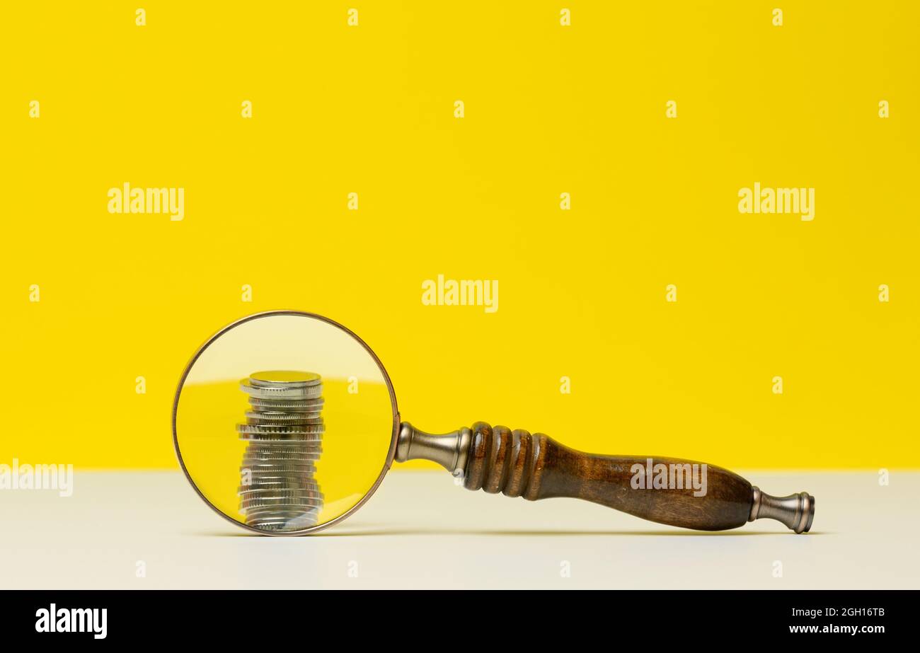 Coin collection with a magnifying glass hi-res stock photography and ...