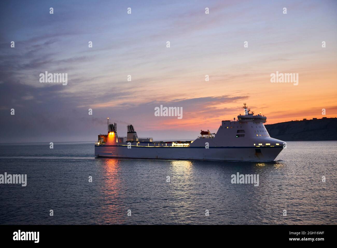 Cargo ship arriving to the Port of Bilbao at sunset, Biscay, Basque ...