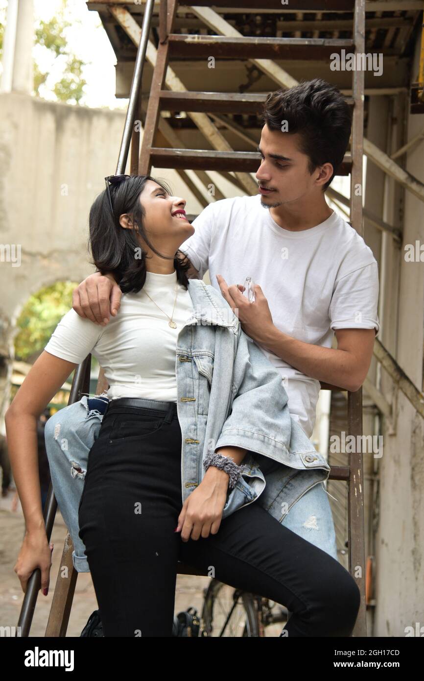 Young Southeast Asian female leaning on her boyfriend's lap at the ...