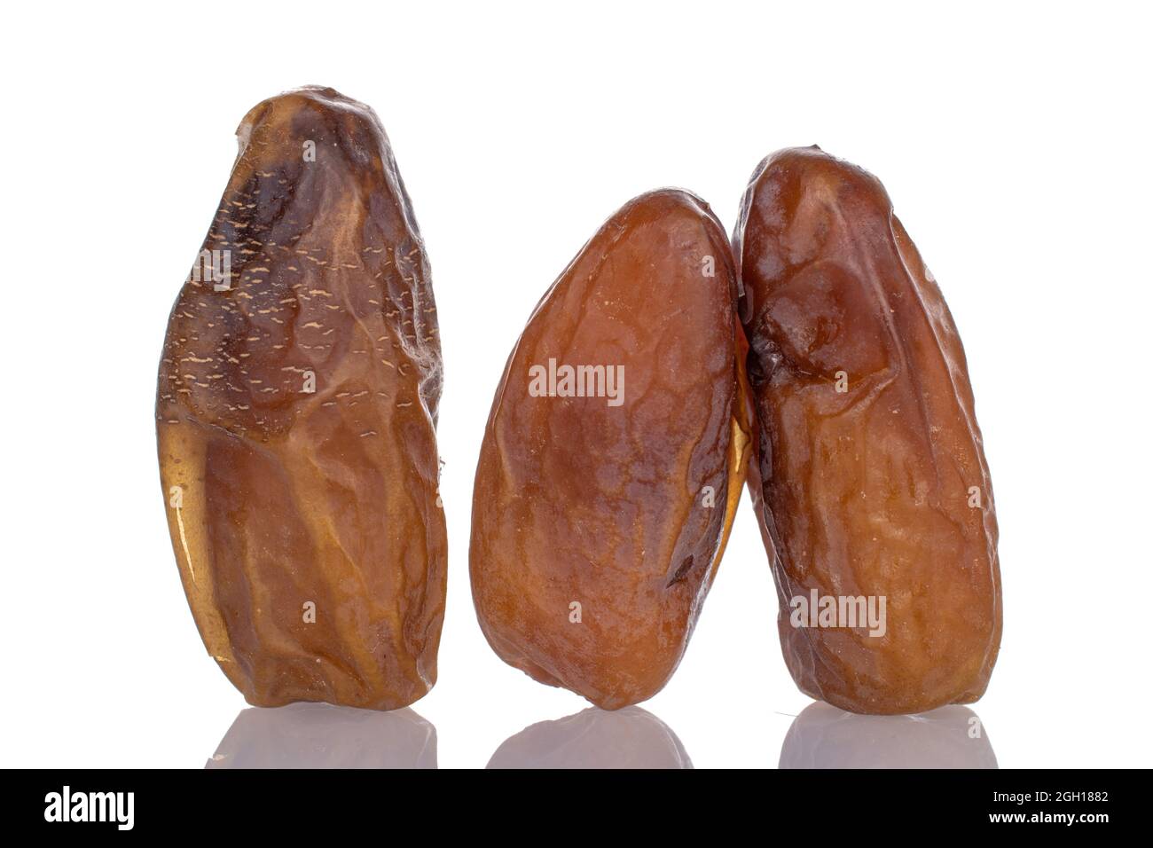 Three natural dried dates, close-up, isolated on white Stock Photo - Alamy