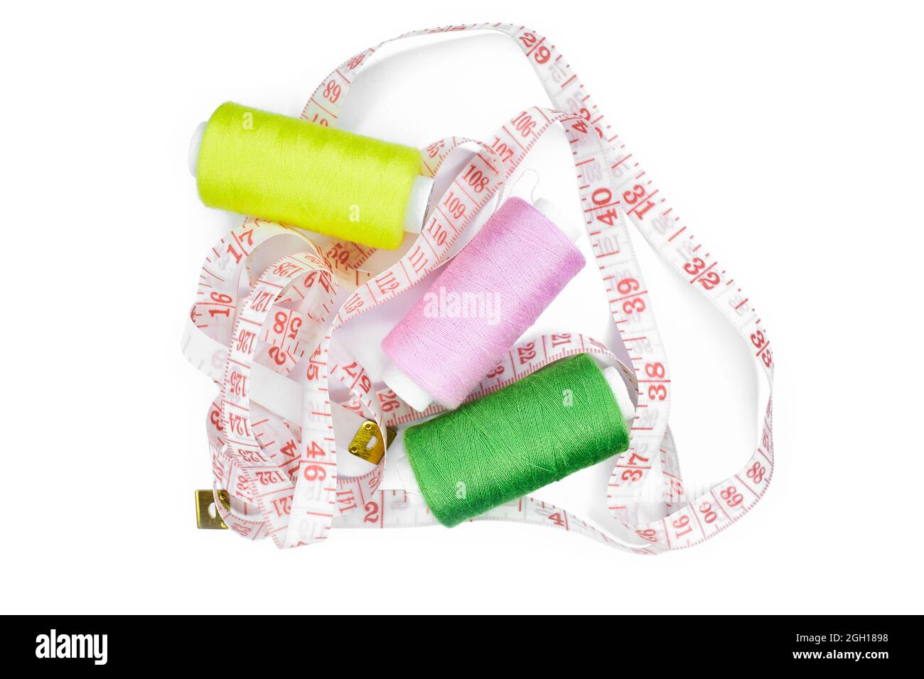 Set of sewing accessories: The white measuring centimetric tape and ...