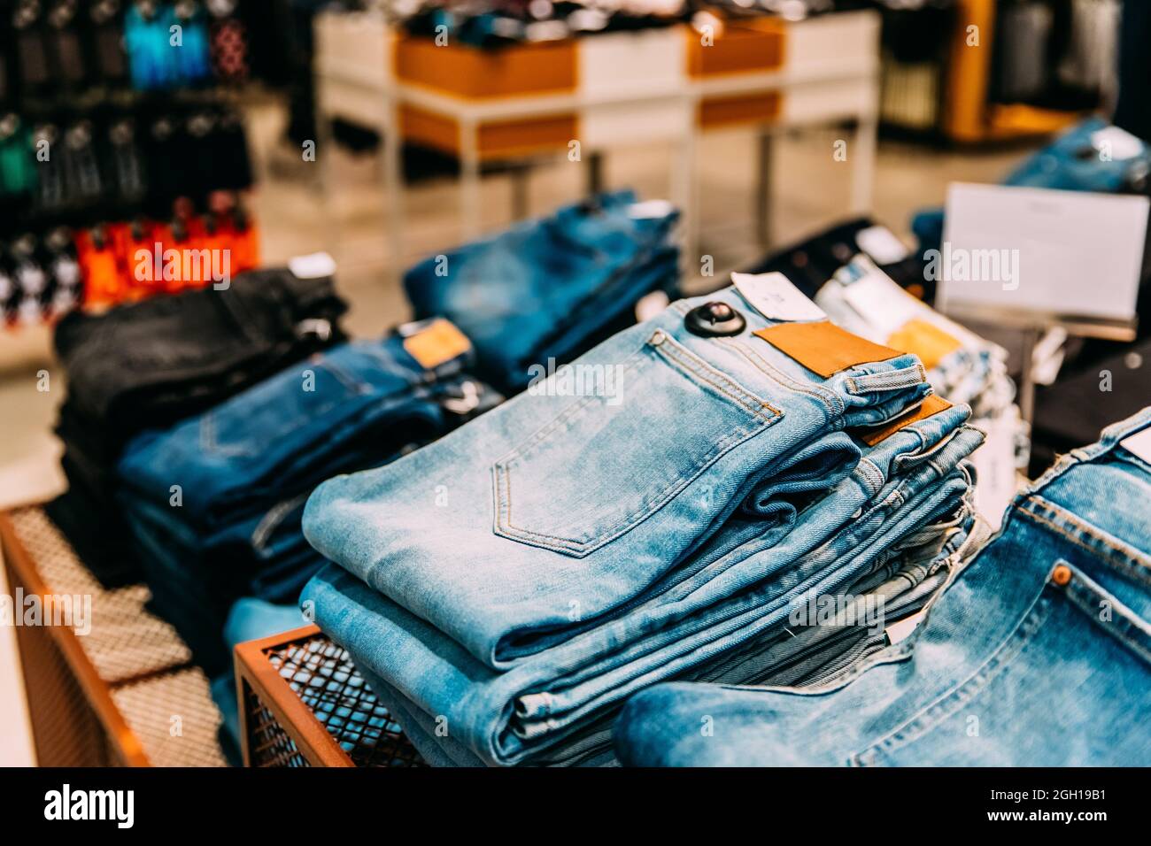 Stack Of Jeans On Shelves In Store Of Shopping Center Stock Photo - Alamy