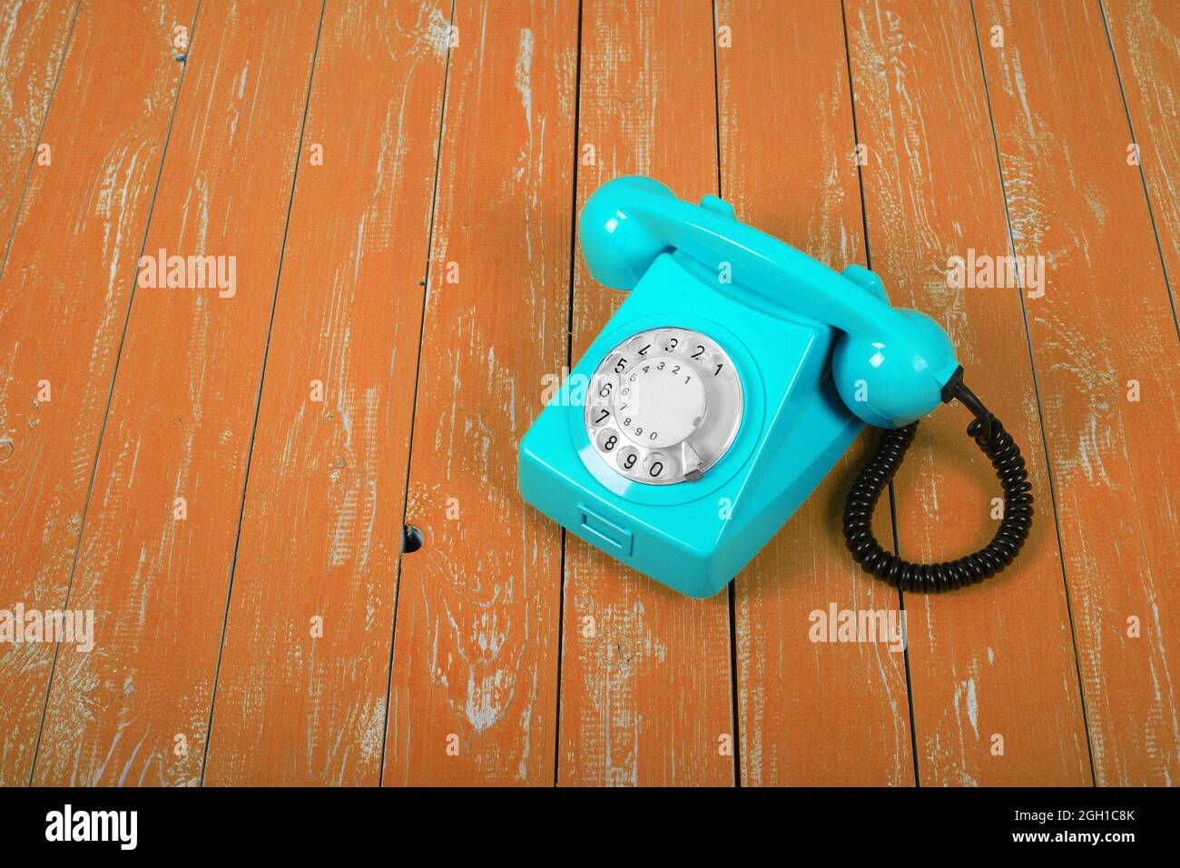 Vintage Phones - Blue retro telephone on a orange wooden background ...