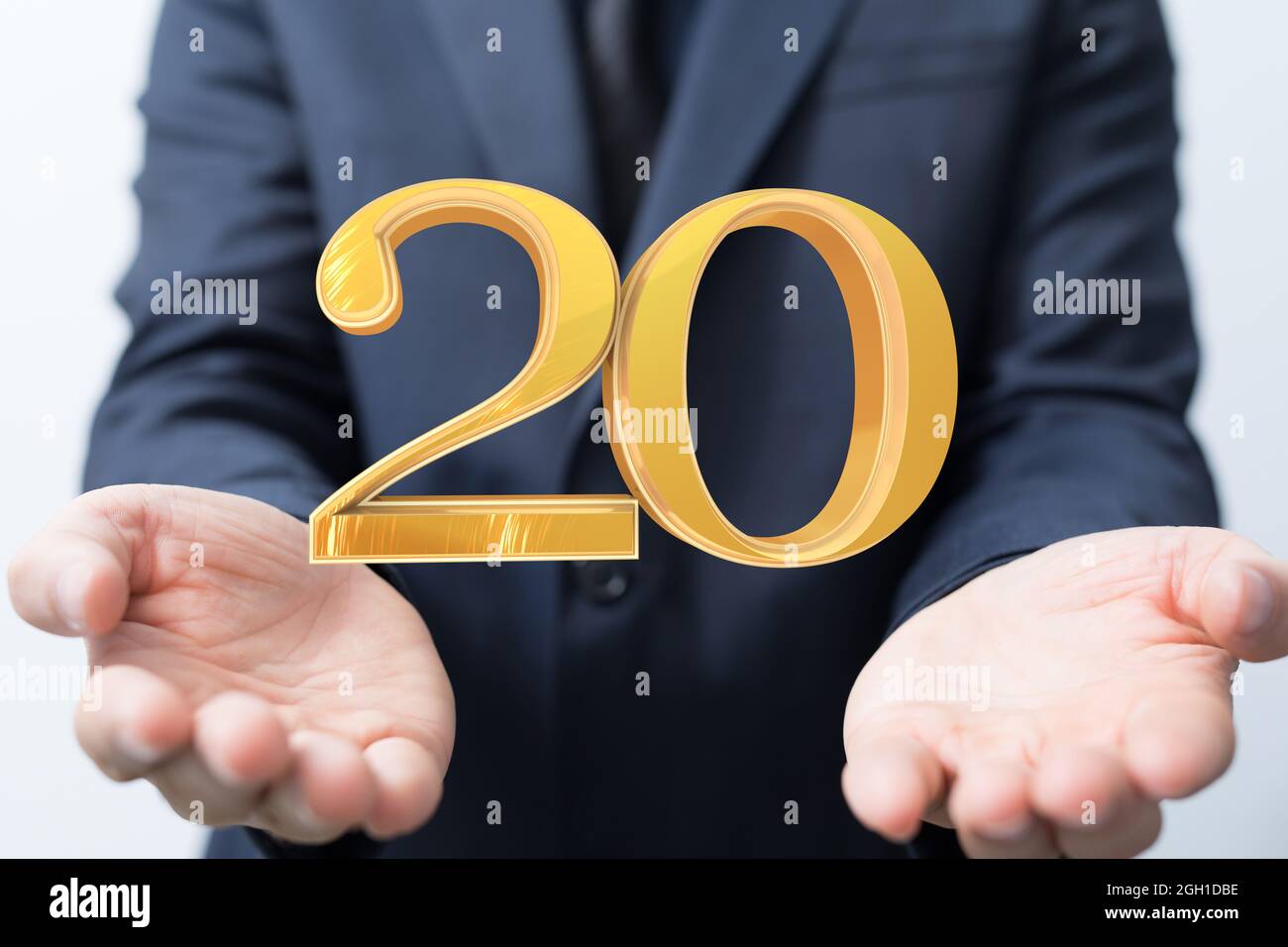 Digital 3d gold 20 number for the anniversary floating on the hands ...