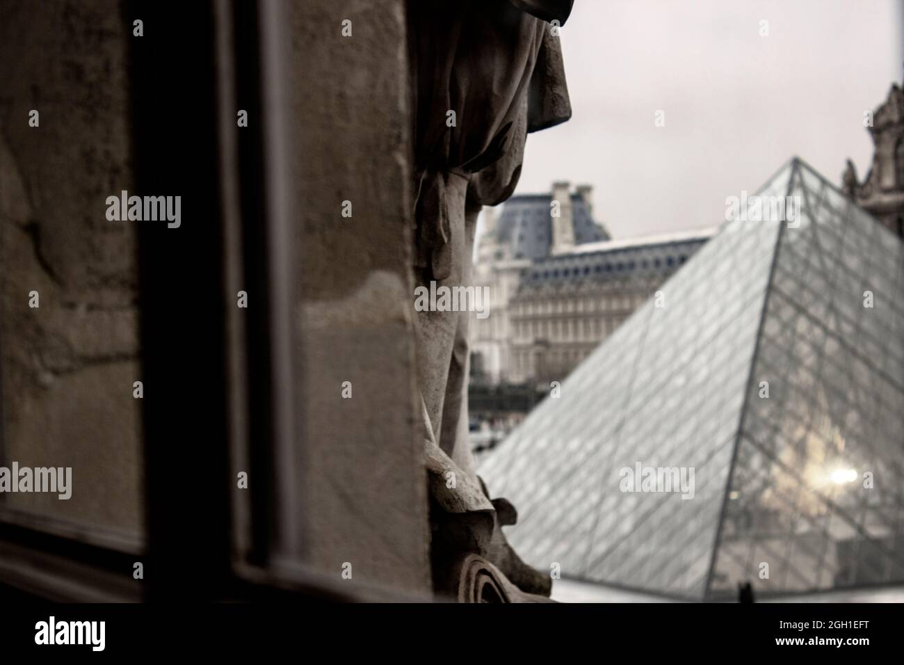 Louvre Pyramid in Paris seen from inside the museum through a window ...