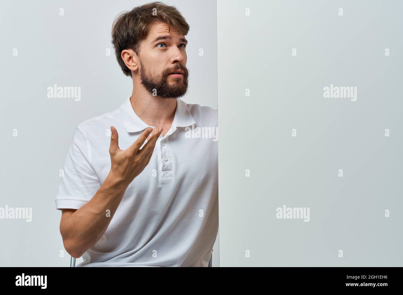 Cheerful man white banner in hand blank sheet presentation copy-space ...