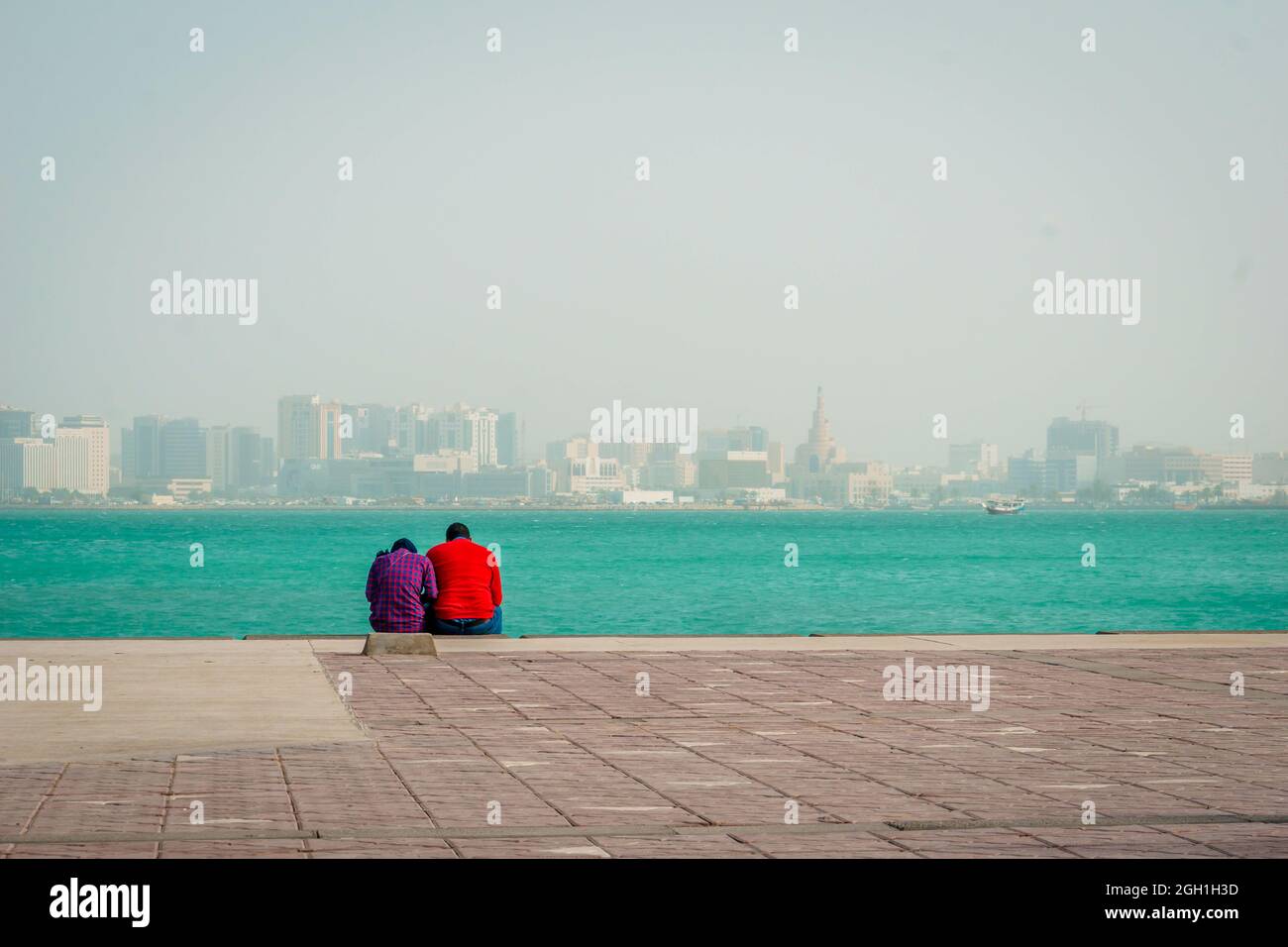 DOHA, QATAR - Mar 01, 2019: A beautiful shot of a lovely couple sitting ...