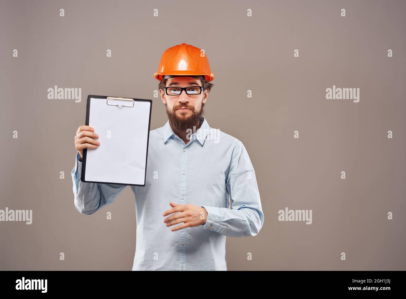 bearded man in orange hard hat engineer documents work Stock Photo - Alamy