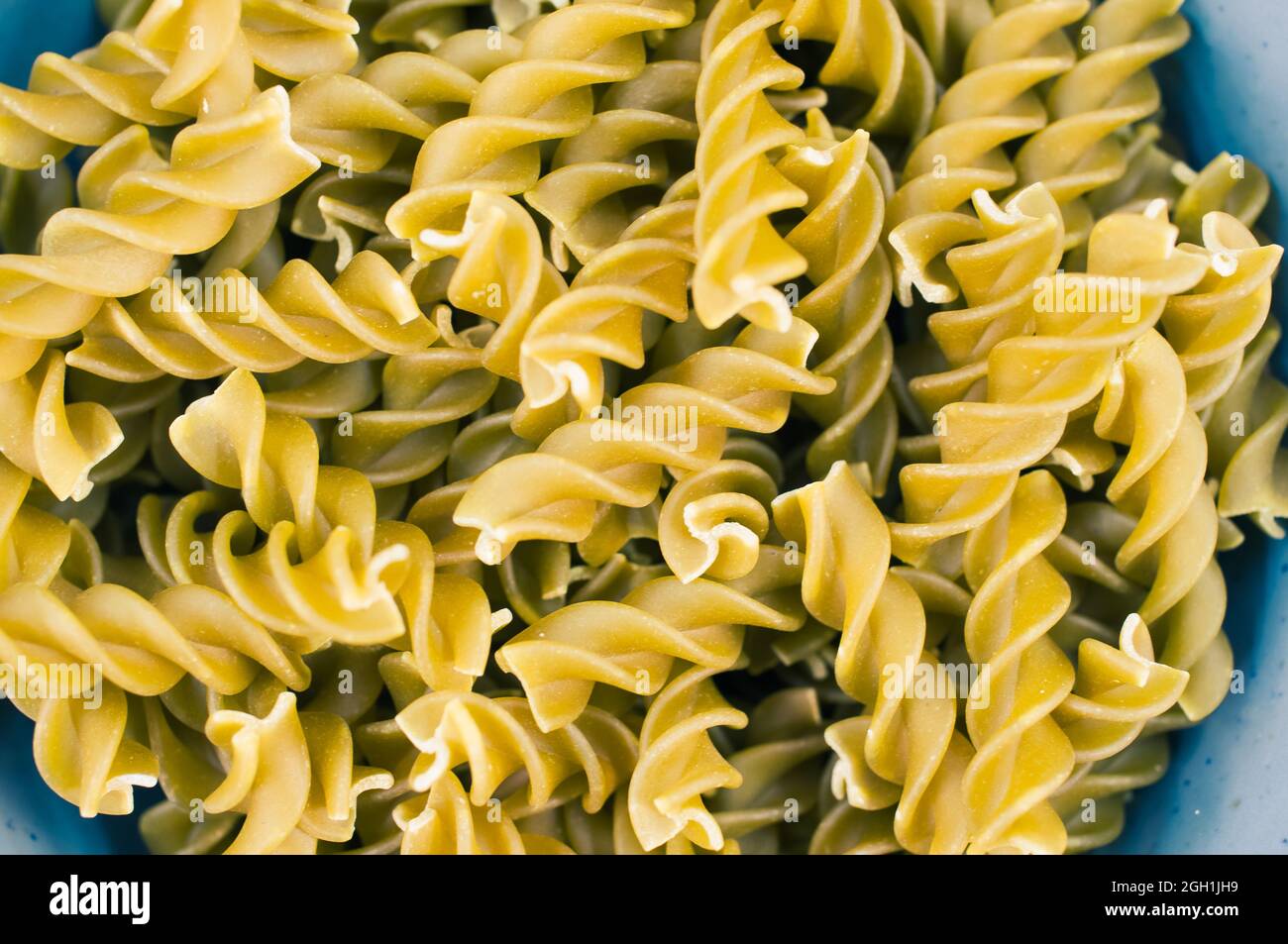 top view of rotini in a blue bowl Stock Photo - Alamy