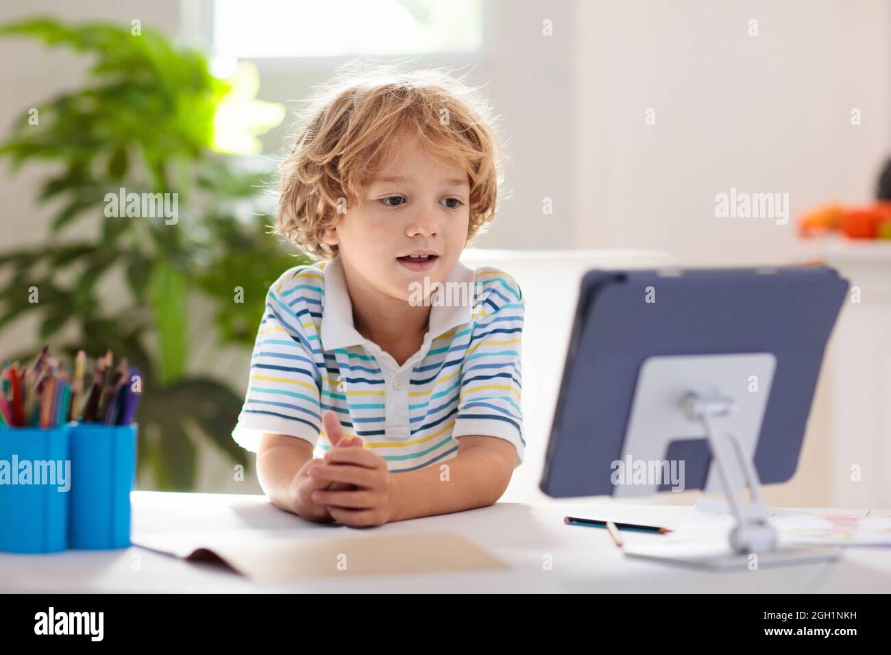 Online remote learning. School kids with computer having video ...