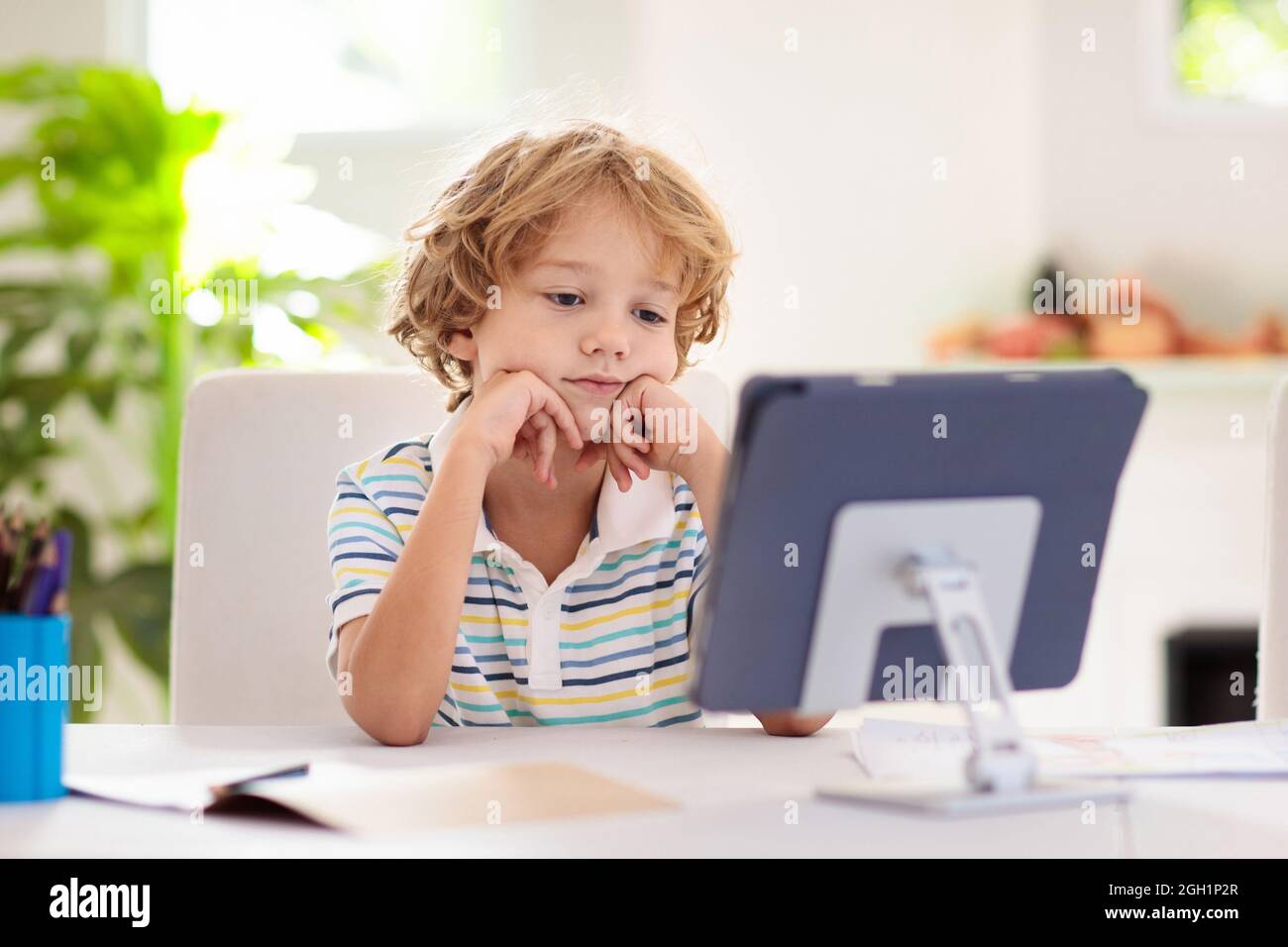 Online remote learning. School kids with computer having video ...