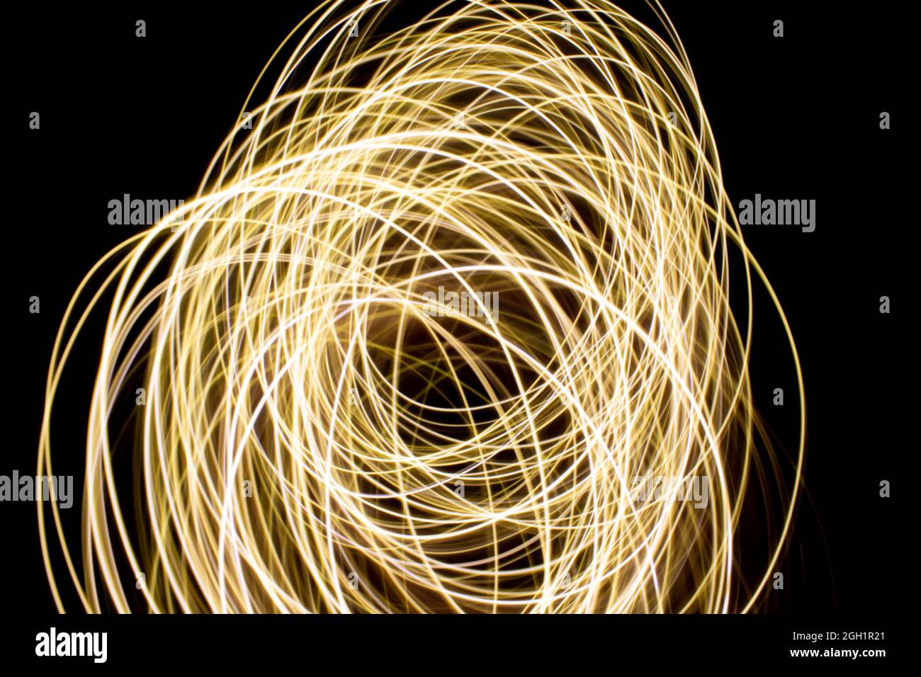 Neon yellow gold abstract swirl, light painting yellow pattern against ...