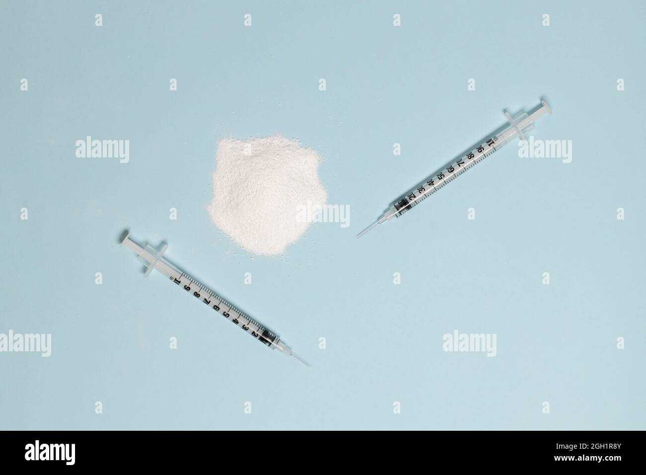 Cocaine or heroin narcotic drug powder and two syringes with a needle ...
