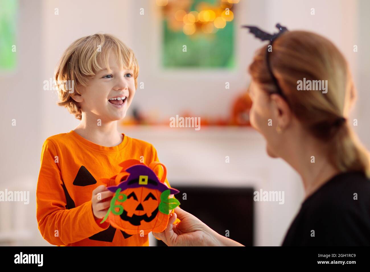 Kids trick or treat in Halloween costume. Children in colorful dress up ...