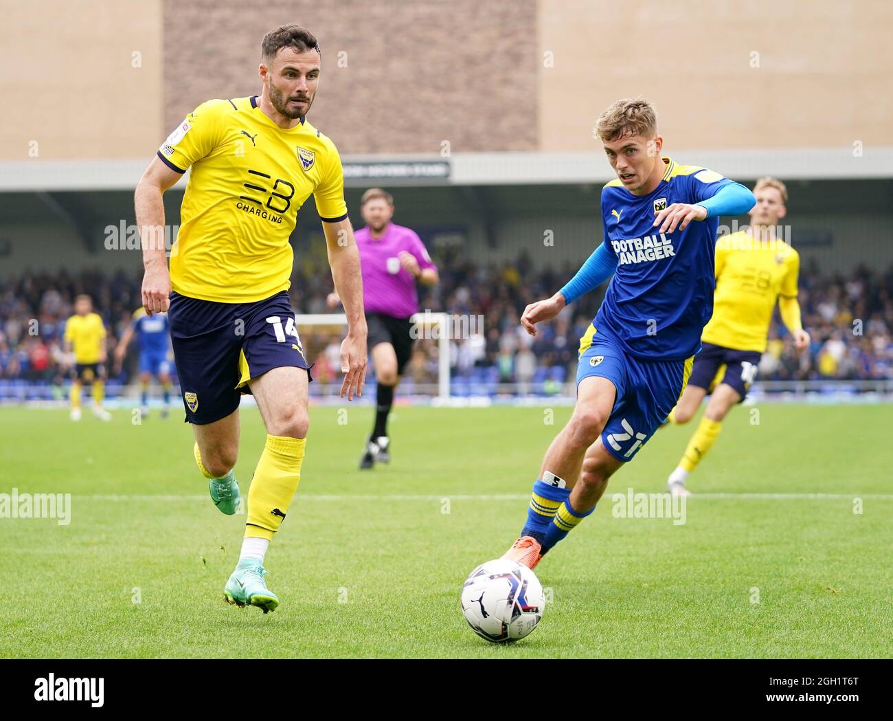 Oxford United's Anthony Forde (left) and AFC Wimbledon's Luke McCormick ...