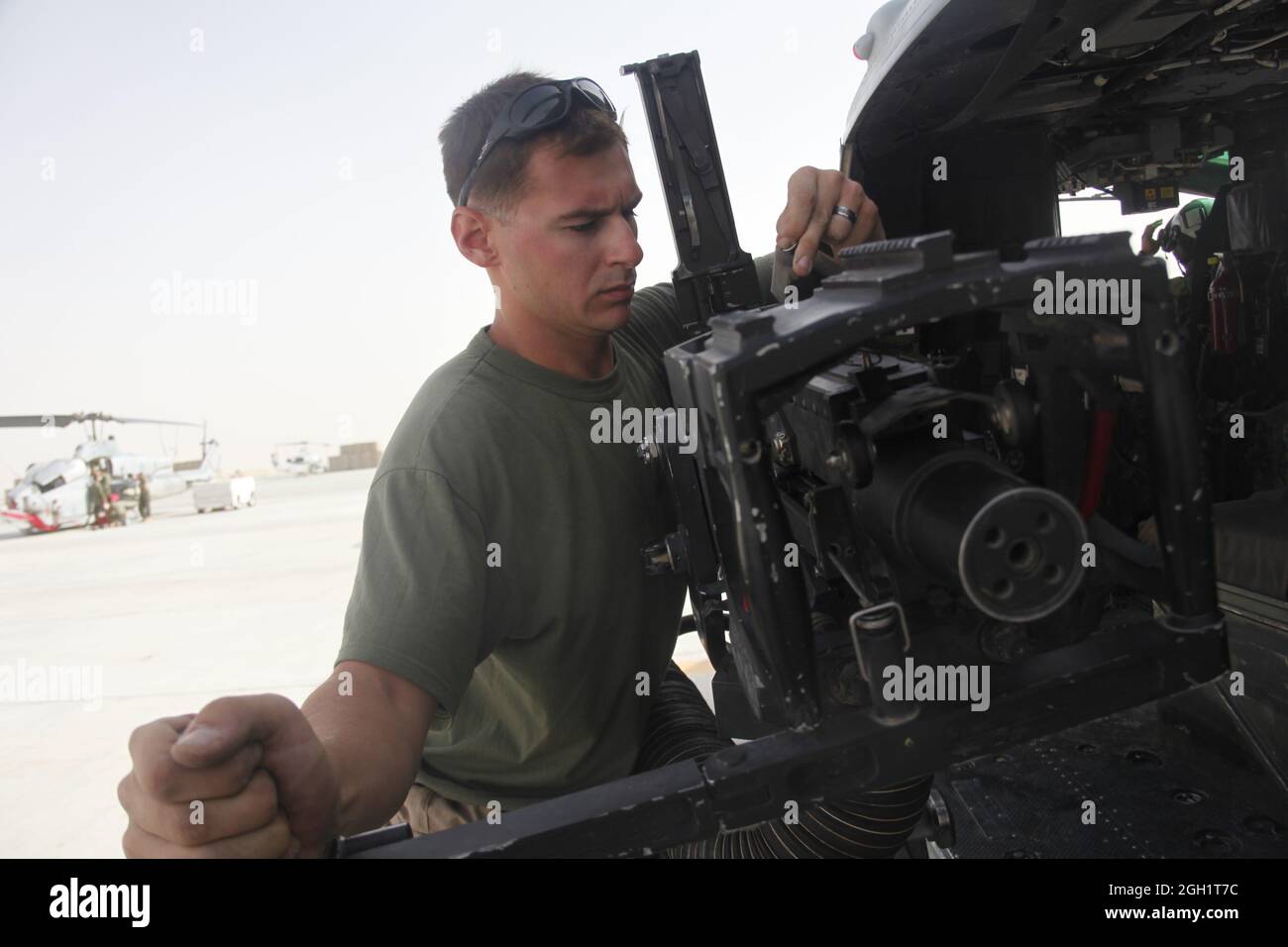 Sgt. Andrew W. Morey readies a .50-caliber machine gun on a UH-1Y Huey ...