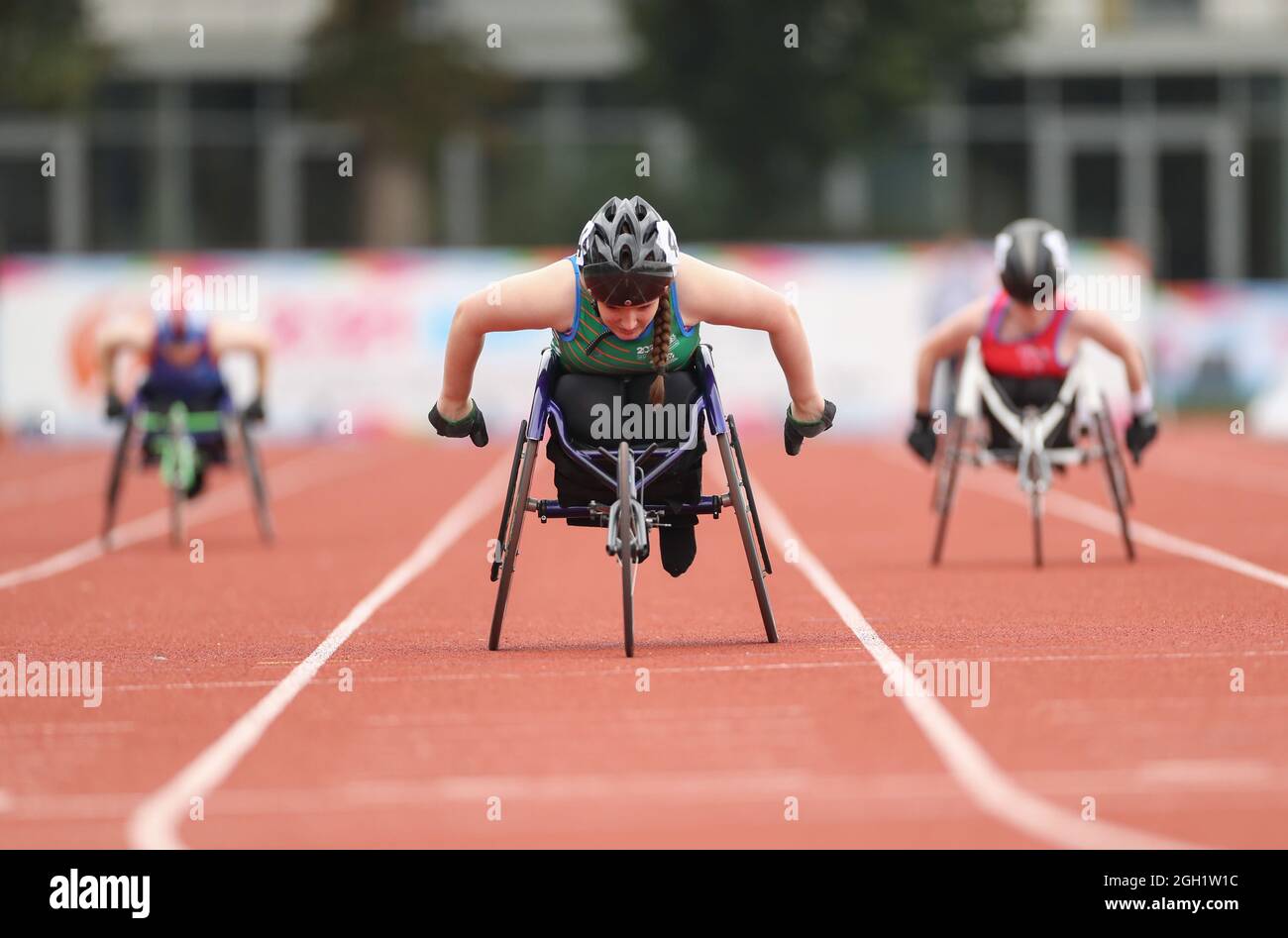 Athletes participate in the girls 100m wheelchair race during Day Three ...