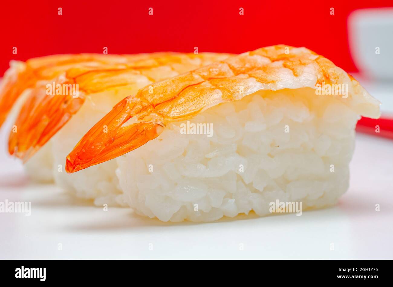 Closeup of ebi king prawn nigiri prepared by a Japanese chef in a ...
