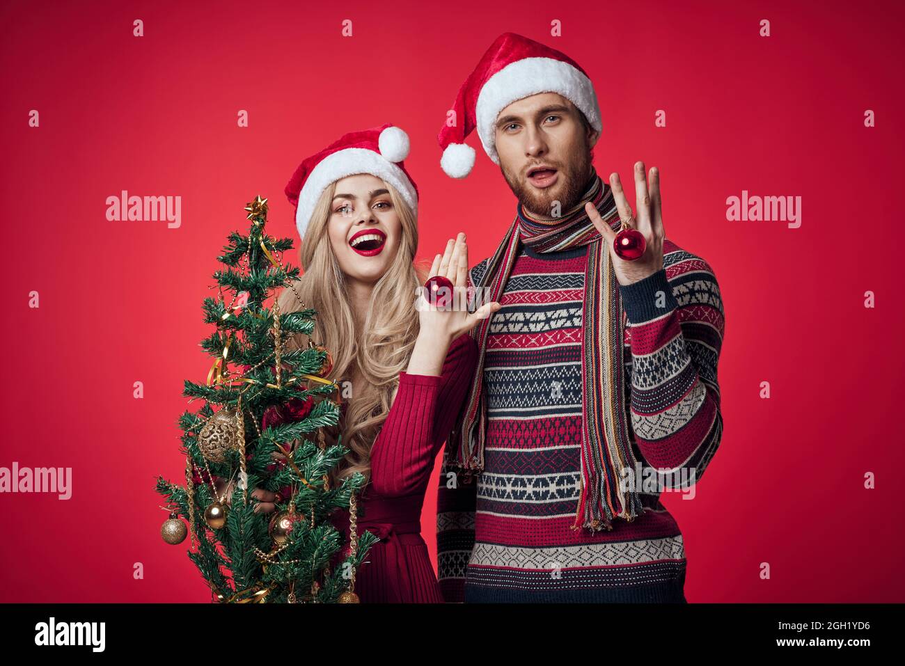 cute young couple celebrate christmas together red background Stock ...