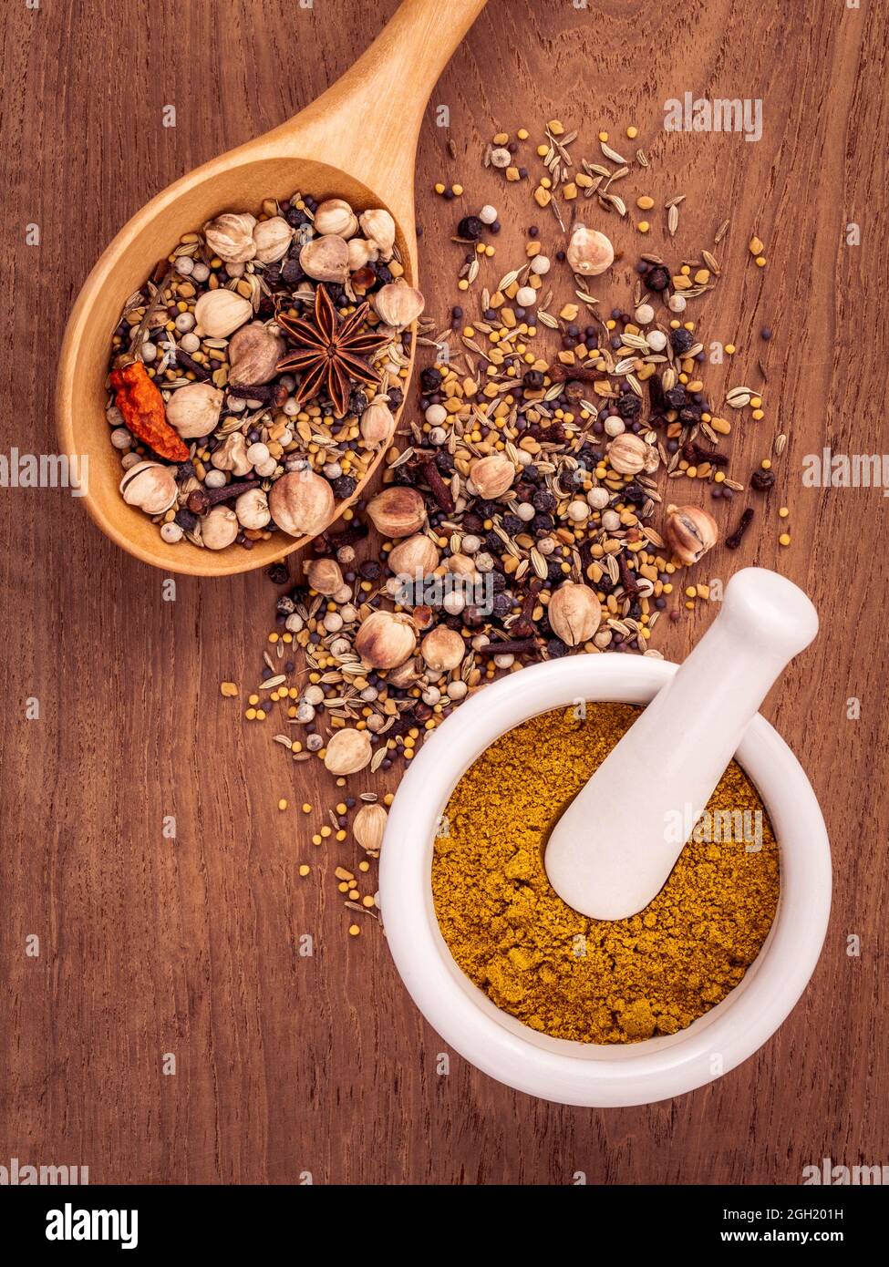 Assorted of spices in wooden spoon black pepper ,white pepper, black ...