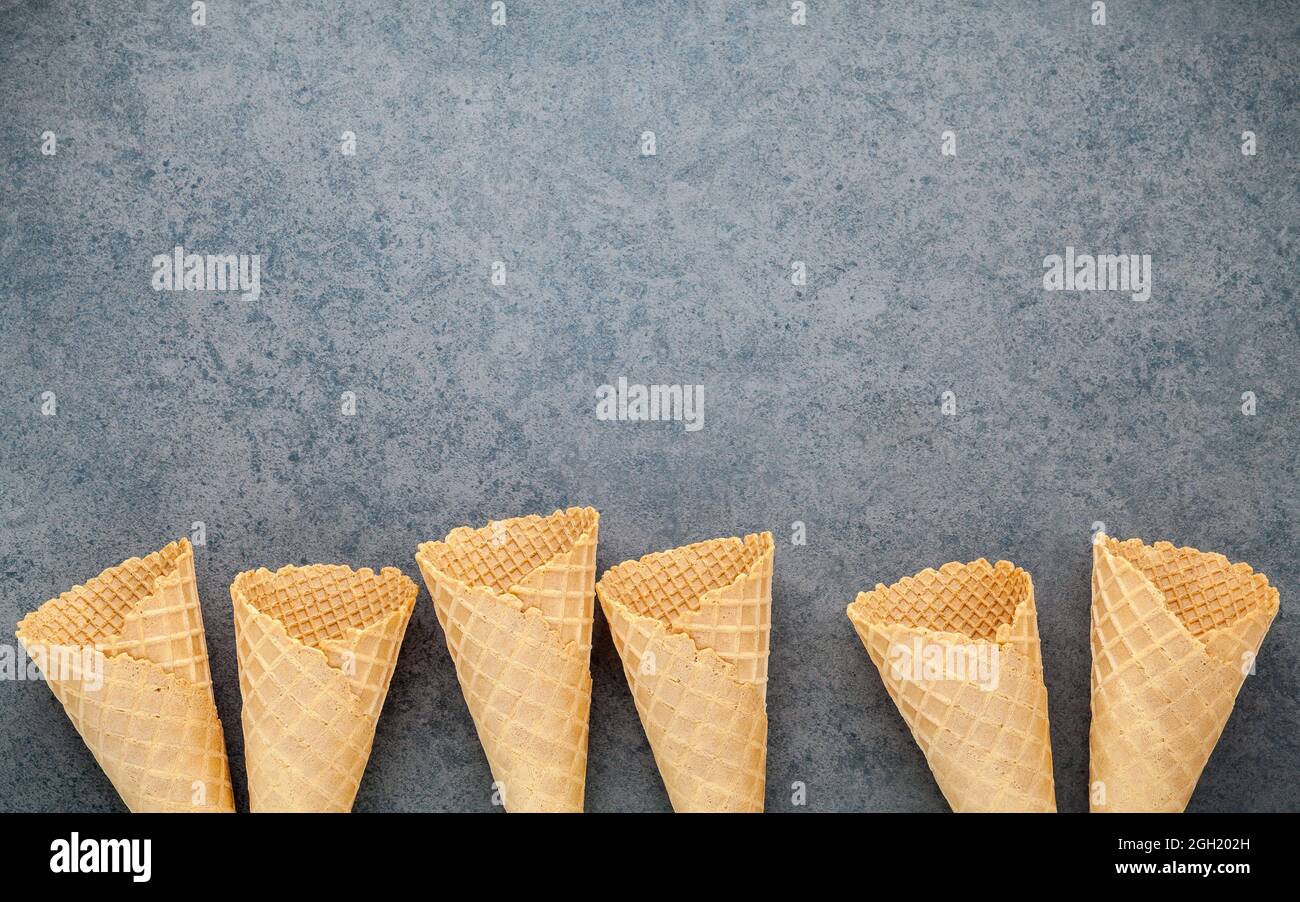 Flat lay ice cream cones collection on dark stone background . Blank ...