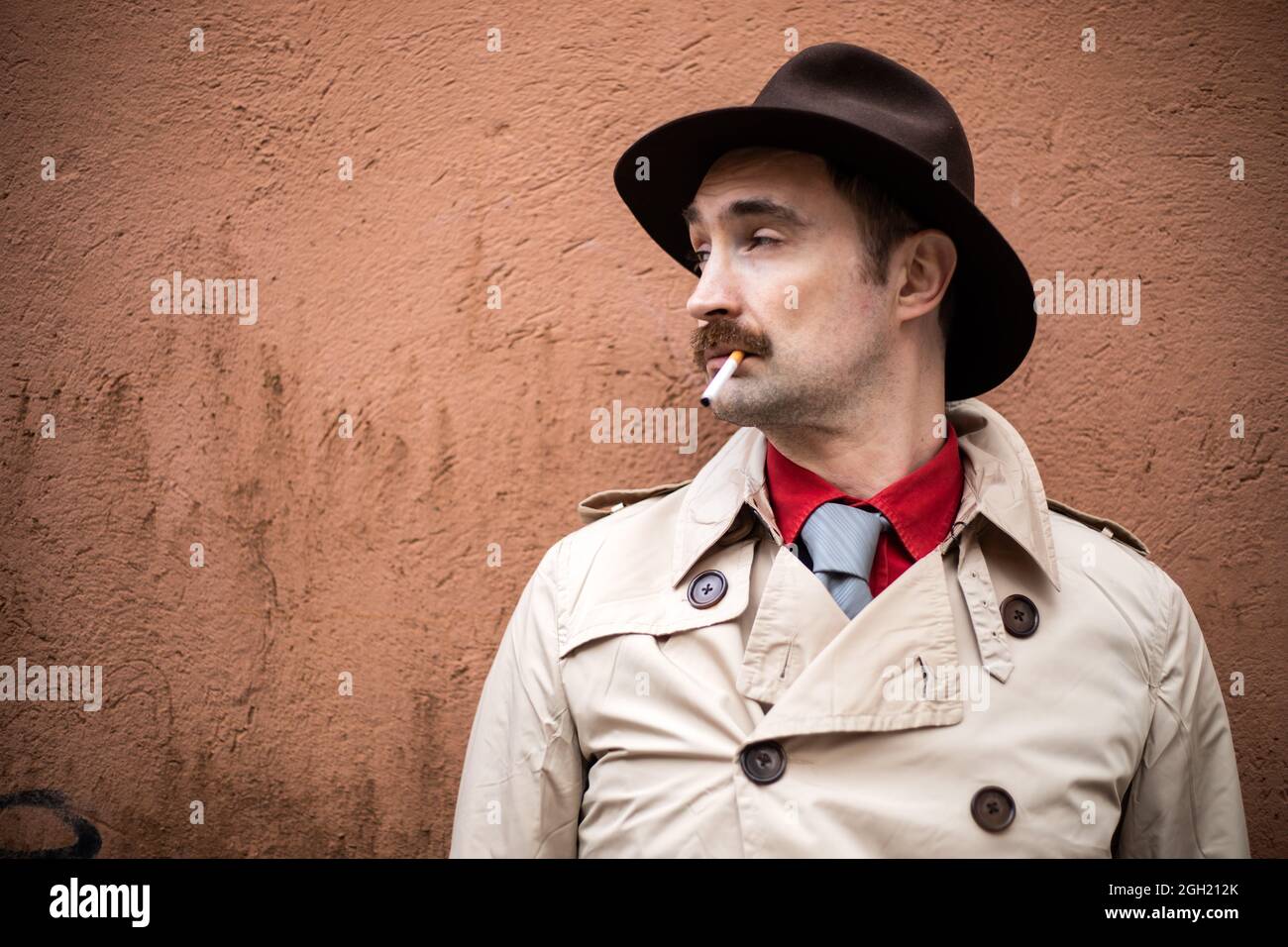 Vintage detective smoking a sigarette ina city slum Stock Photo - Alamy