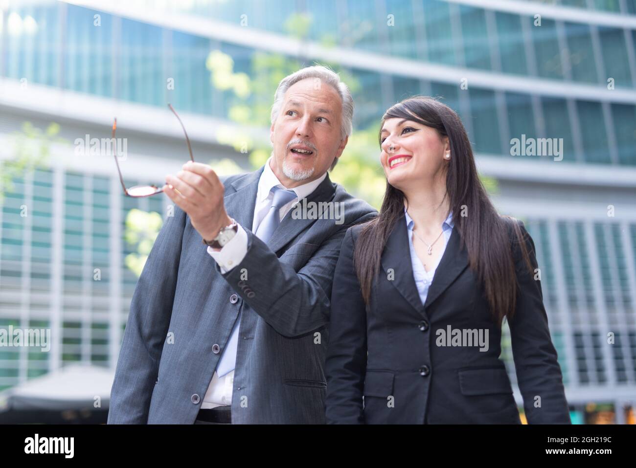 Business people having a conversation in front of their office Stock ...