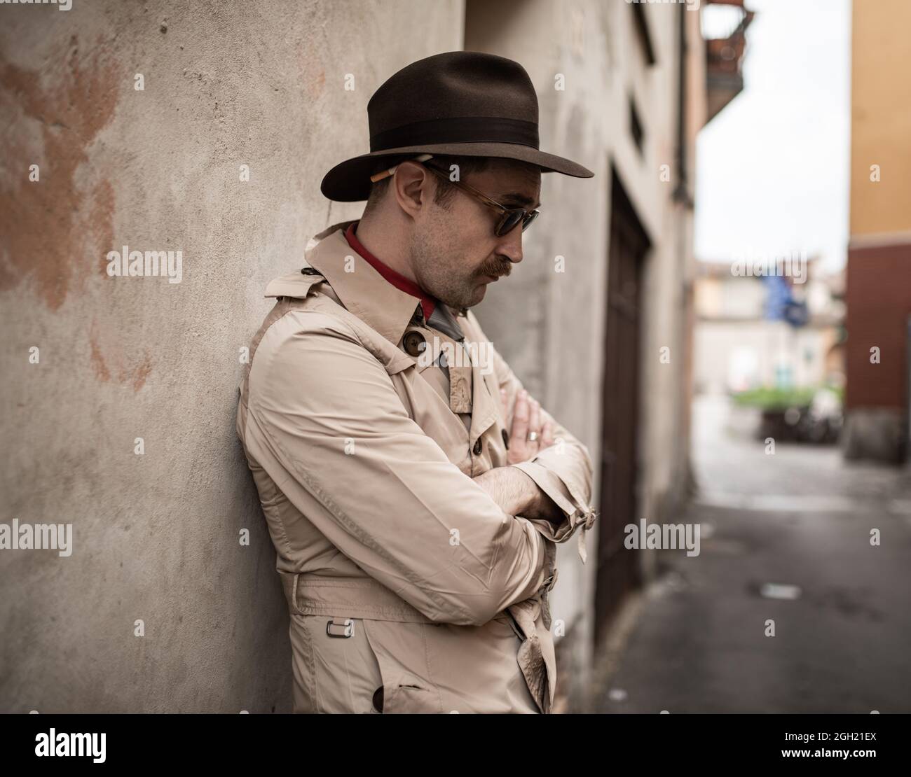 Portrait of a detective near an old wall Stock Photo - Alamy