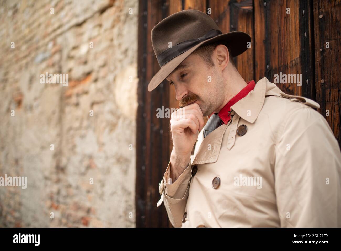 Detective walking alone in the city slums Stock Photo - Alamy