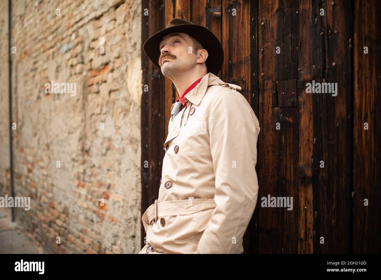 Detective walking alone in the city slums Stock Photo - Alamy